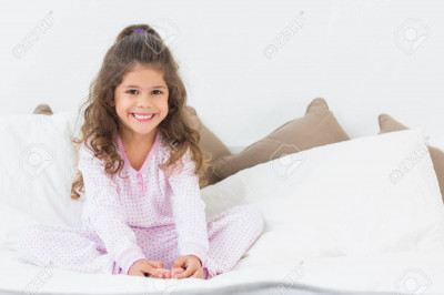 18111362-cute-girl-sitting-on-bed-in-bedroom jigsaw puzzle in PJ Hunter ...